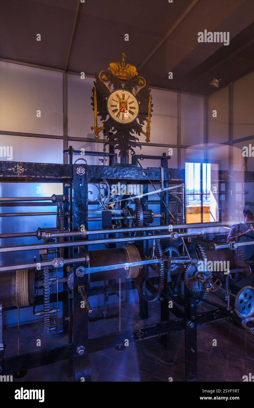 A complex clockwork mechanism with gears, wheels, and a large clock ...