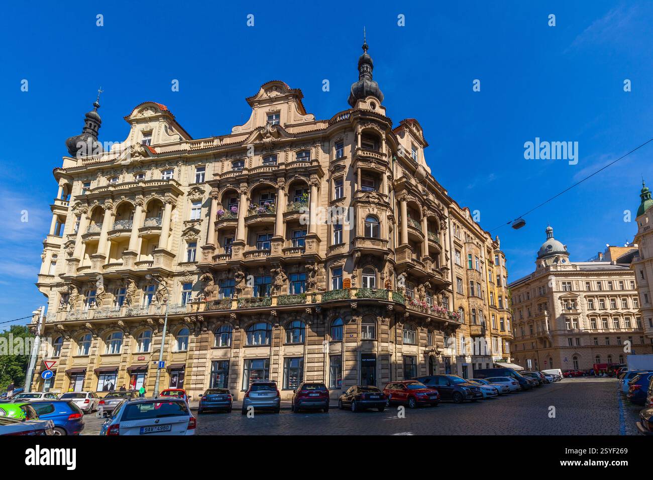 A grand, ornate corner building with decorative details and a rounded ...