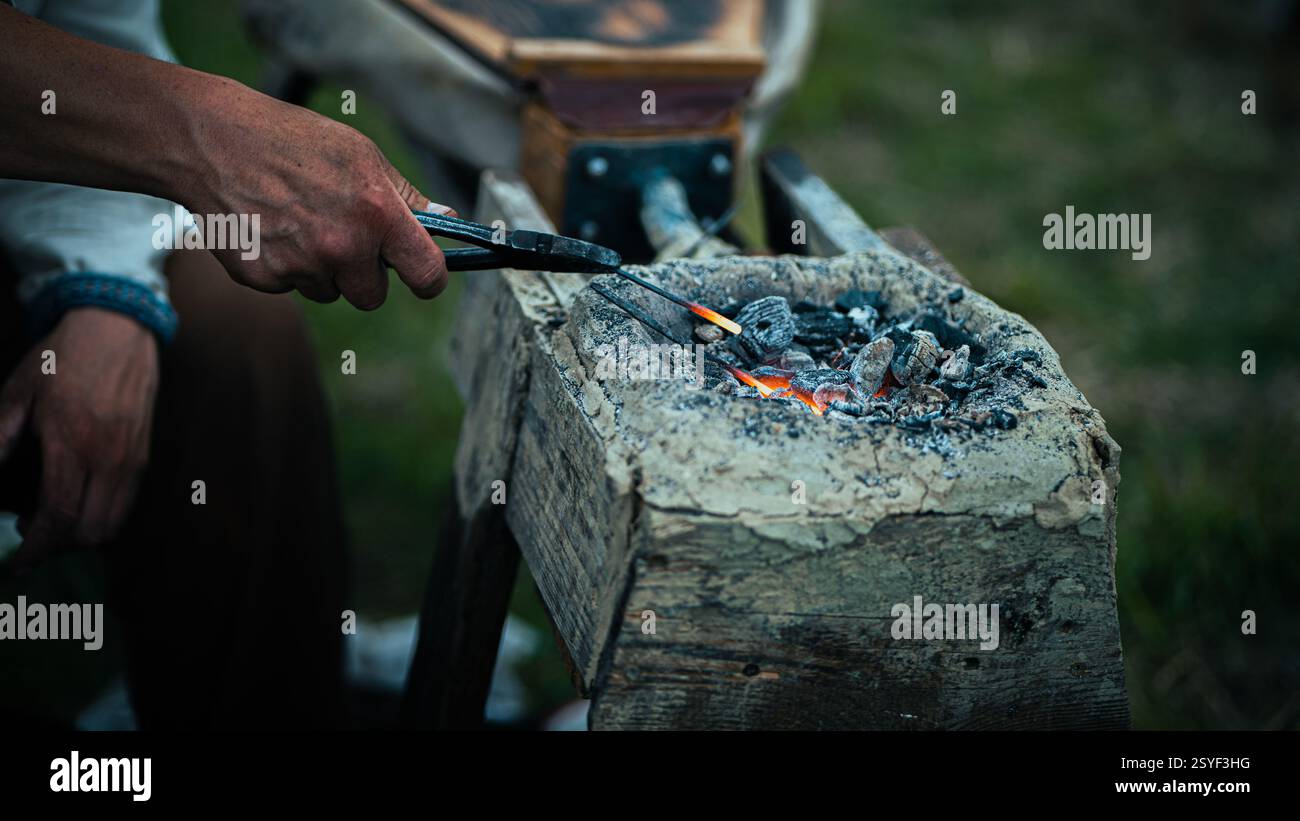 Blacksmith Heating Metal in Fire for Forging Stock Photo - Alamy
