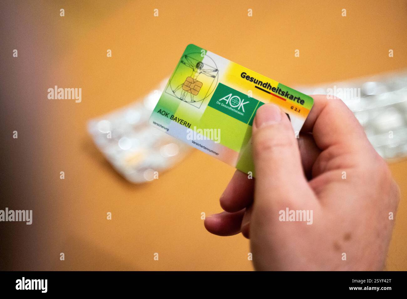 Munich, Bavaria, Germany - February 27, 2025: A hand holds an AOK ...