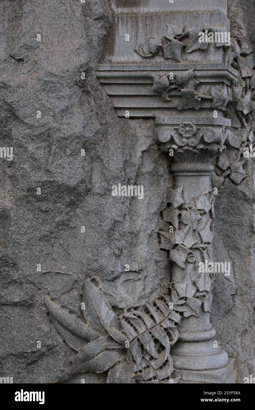 A column with ivy growing around it is carved in a stone monument Stock ...