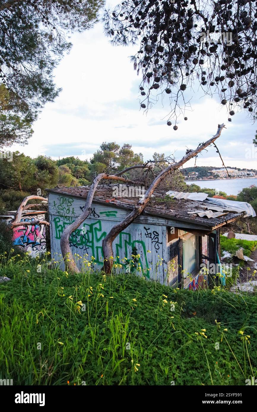 Vouliagmeni, Greece - February 28, 2025. An old, dilapidated wooden ...