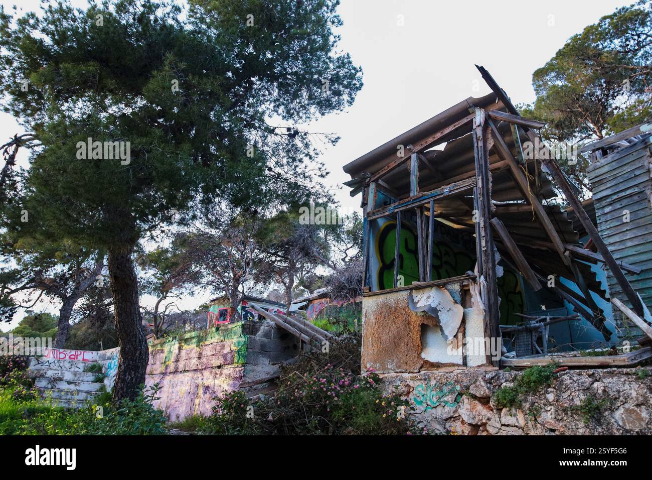 Vouliagmeni, Greece - February 28, 2025. An old, dilapidated wooden ...