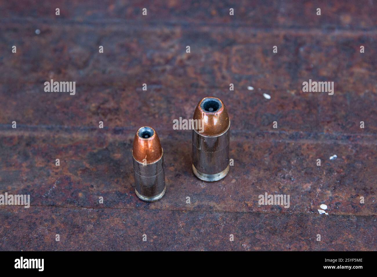 Comparing the sizes between a .45 ACP and 9mm cartridge. The smaller ...