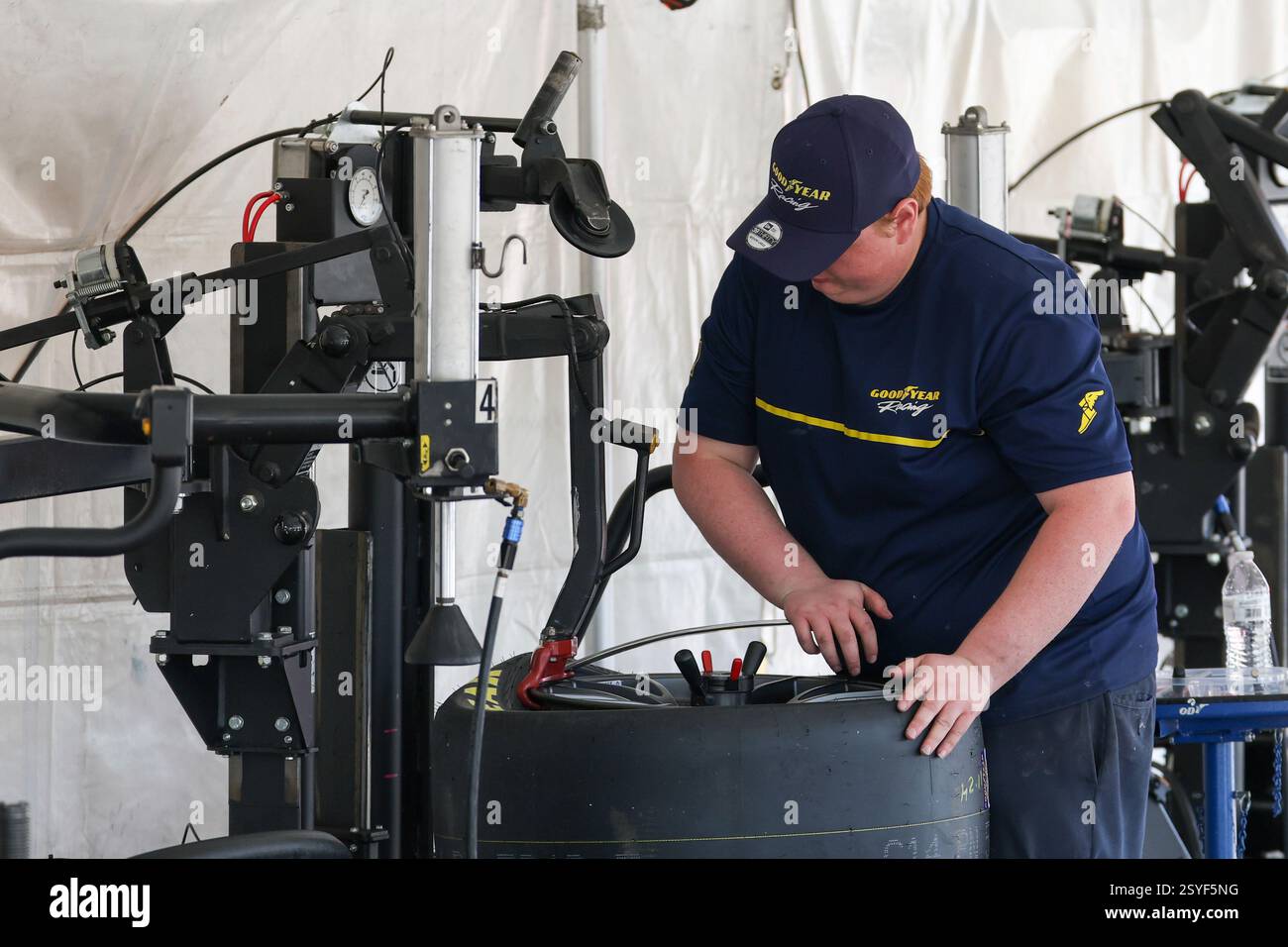 AUSTIN, TX - FEBRUARY 28: A Goodyear tire mechanic works on a tire ...