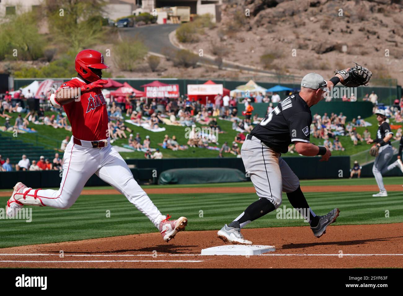 Chicago White Sox first baseman Andrew Vaughn, right, makes a catch to ...