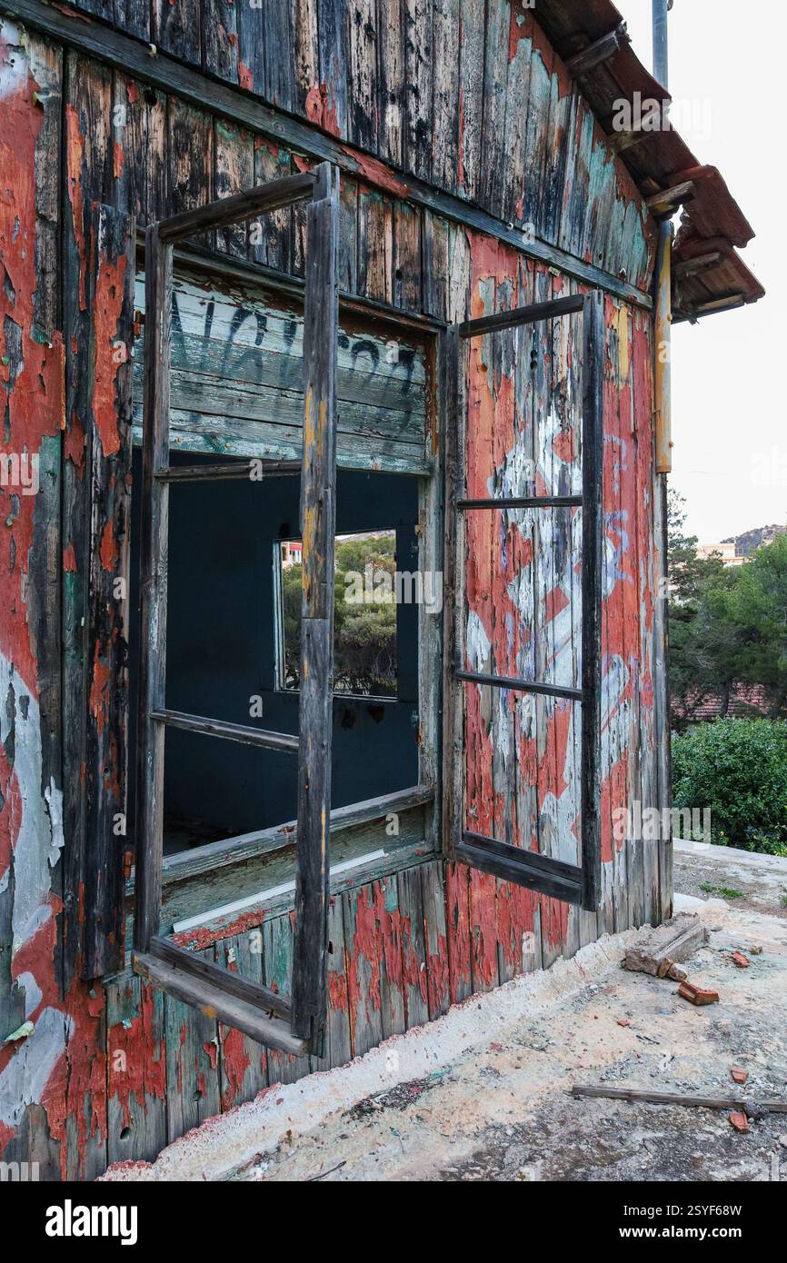 Vouliagmeni, Greece - February 28, 2025. An old, dilapidated house with ...