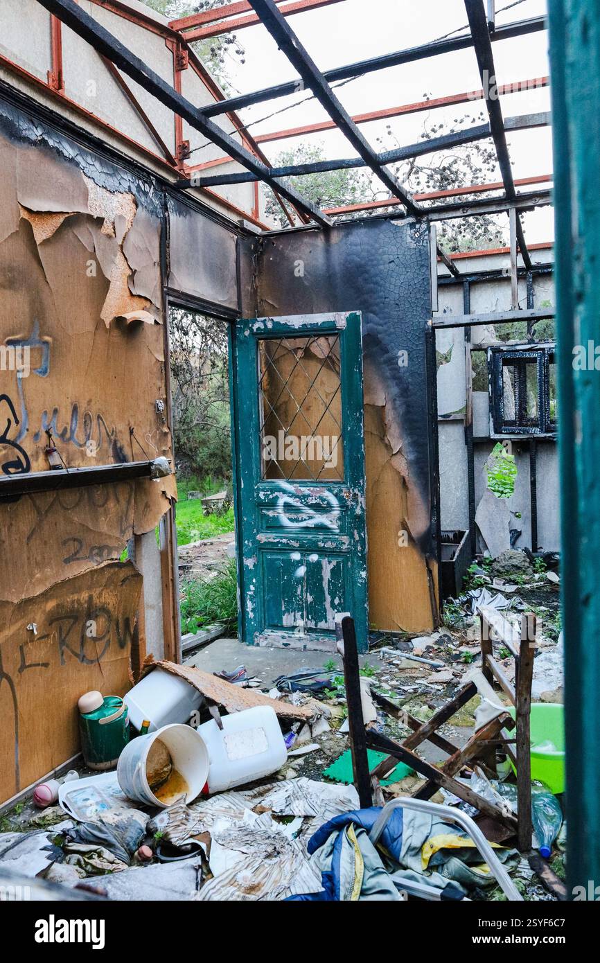 Vouliagmeni, Greece - February 28, 2025. An old, dilapidated house ...