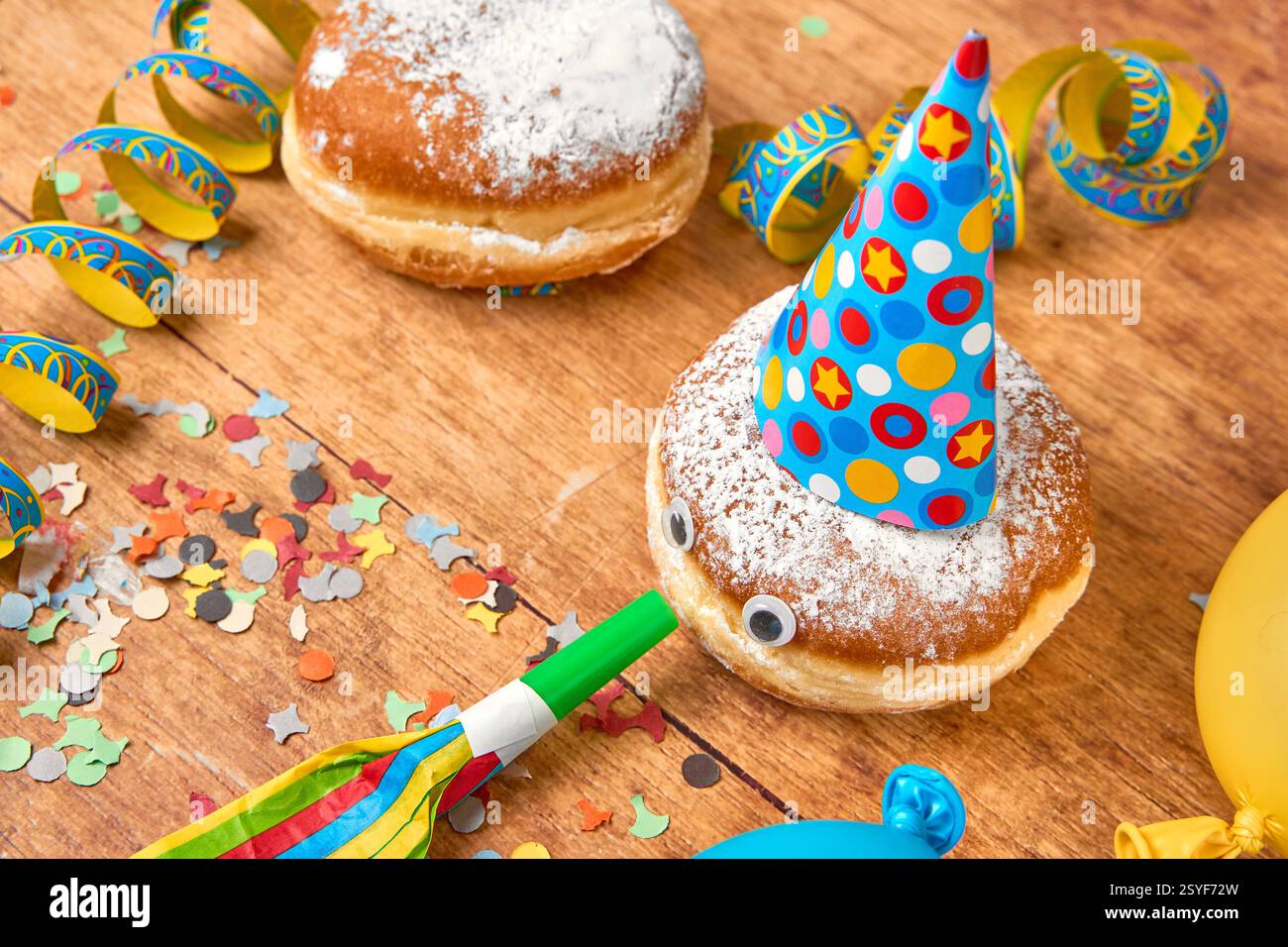 Germany - February 28, 2025: A Berliner with wiggly eyes, a party hat ...