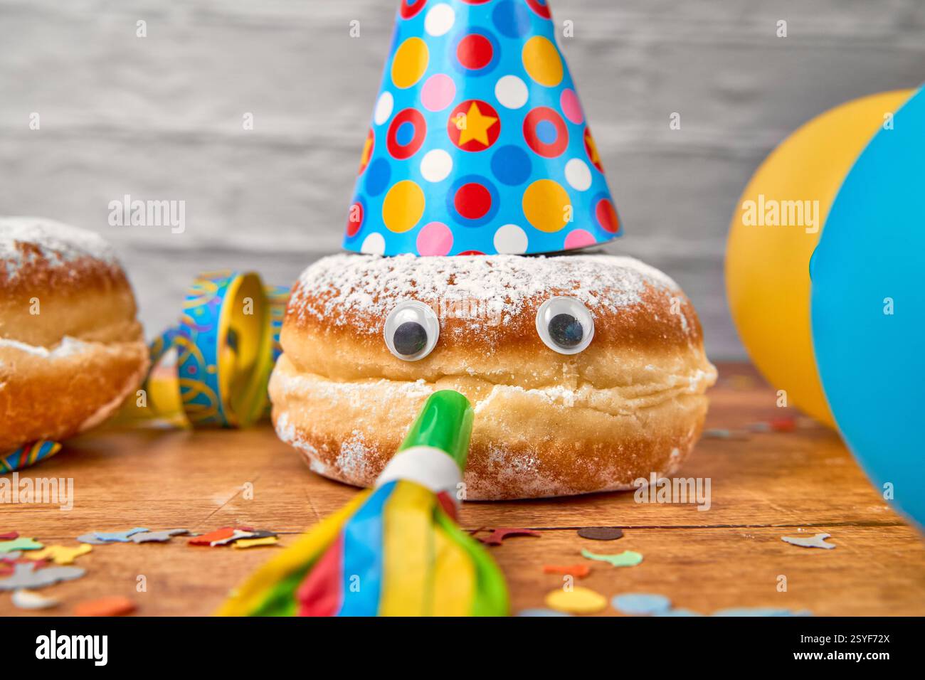 Germany - February 28, 2025: A Berliner with wiggly eyes, a party hat ...