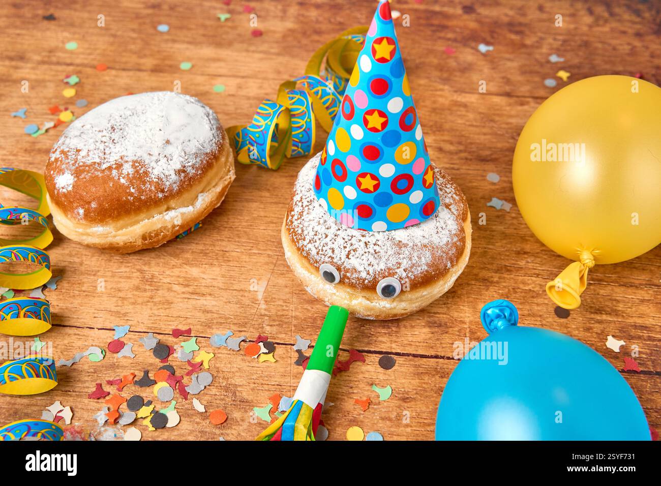 Germany - February 28, 2025: A Berliner with wiggly eyes, a party hat ...