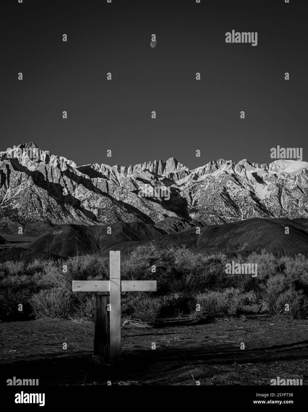 An old cross marks a grave in a cemetery in the Owens Valley with a ...