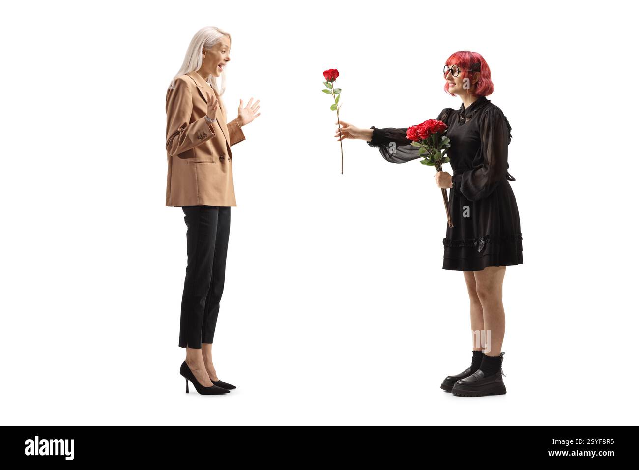 Young female giving a rose to a surprised woman isolated on white ...