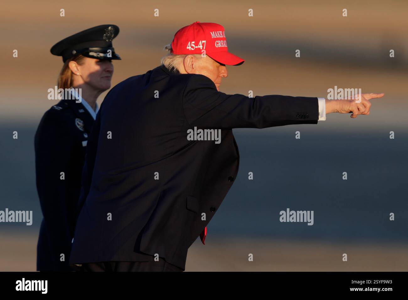 President Donald Trump, right, gestures as is escorted by Air Force Col ...