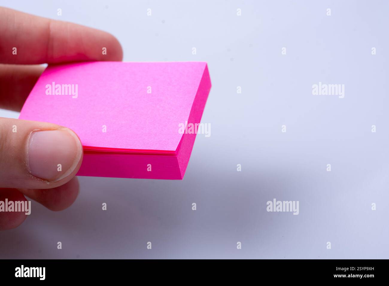 Post note office sticker for taking notes in hand Stock Photo - Alamy