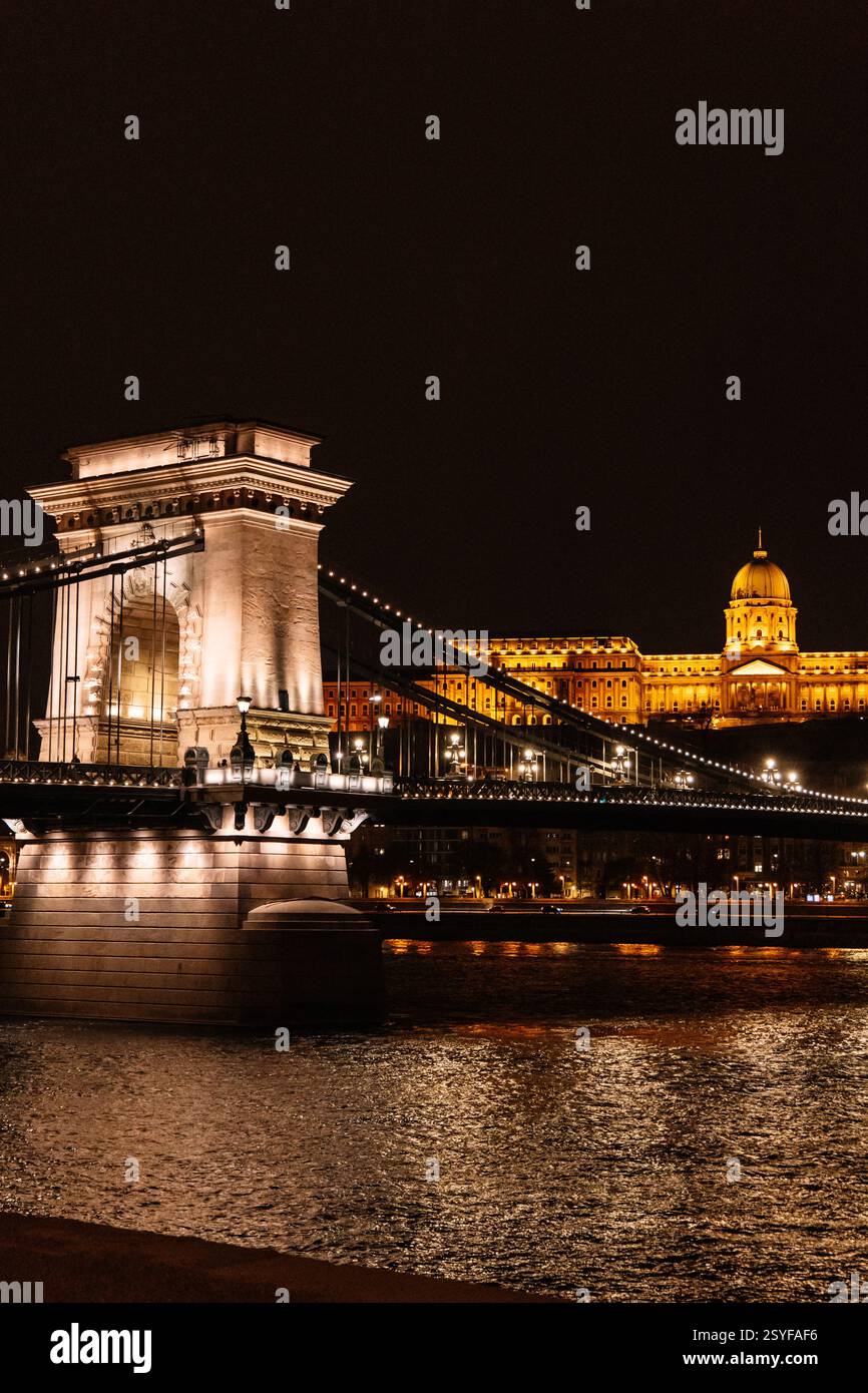 02-17-2025, Budapest. vertical Széchenyi Chain Bridge and Buda Castle are glowing at night ...