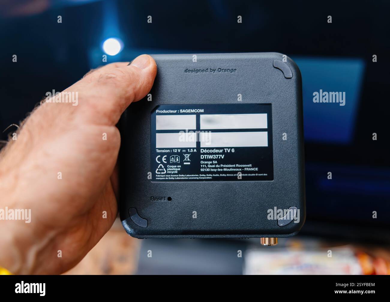 Paris, France - Feb 17, 2025: A person holds an Orange TV Decoder TV 6 ...