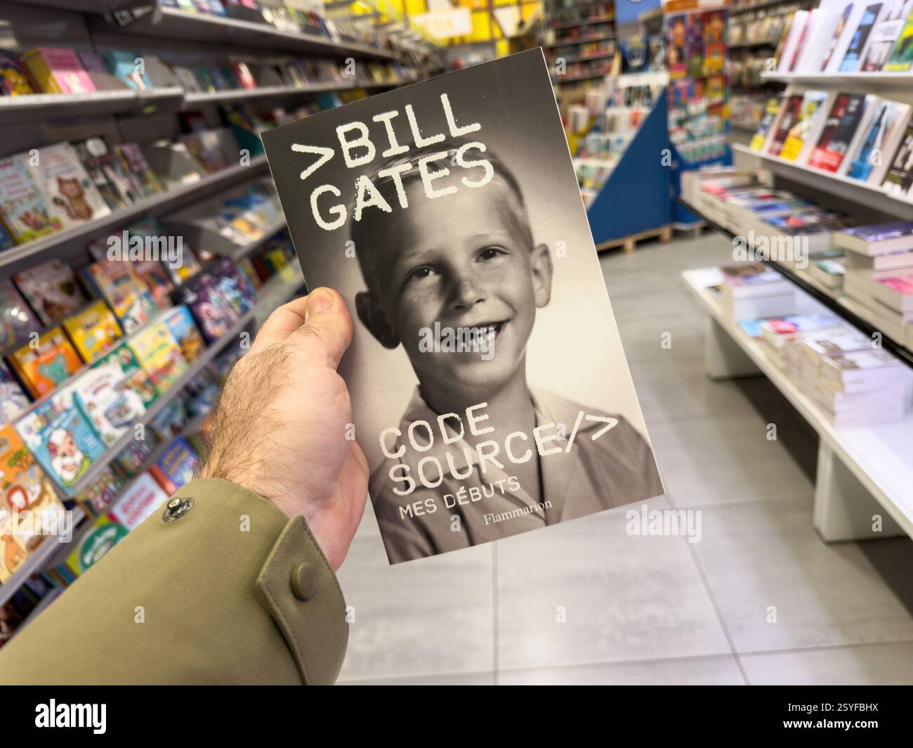 Paris, France - Feb 18, 2025: A person holds a French edition of Bill ...