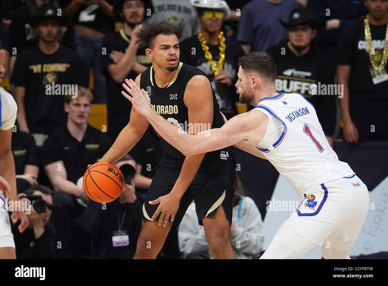 Colorado center Elijah Malone (50) and Kansas center Hunter Dickinson ...