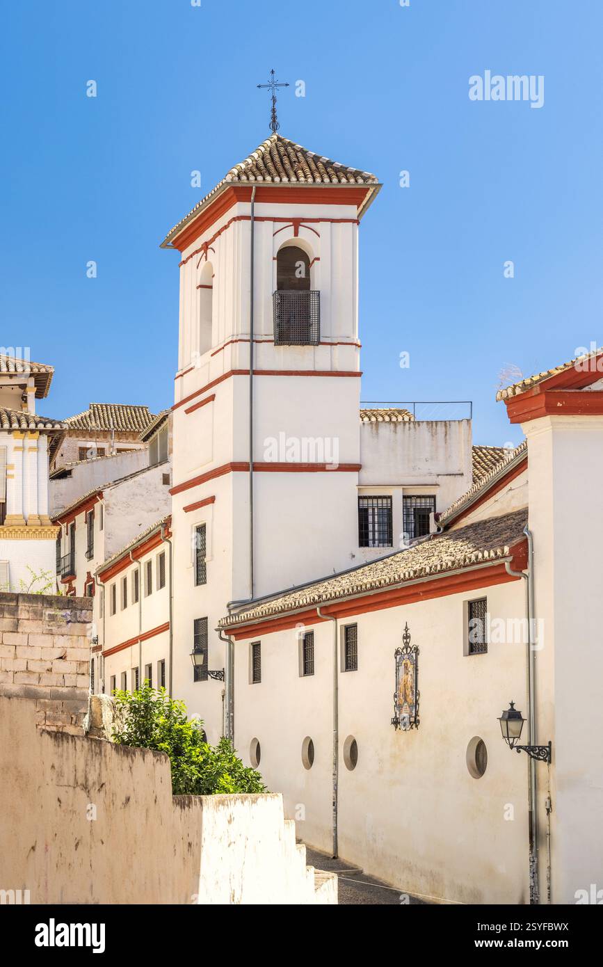 Granada town in Spain. Whitewashed building with red trim and bell ...