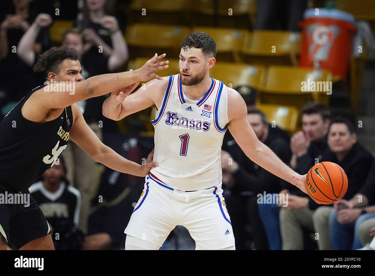 Colorado center Elijah Malone (50) and Kansas center Hunter Dickinson ...