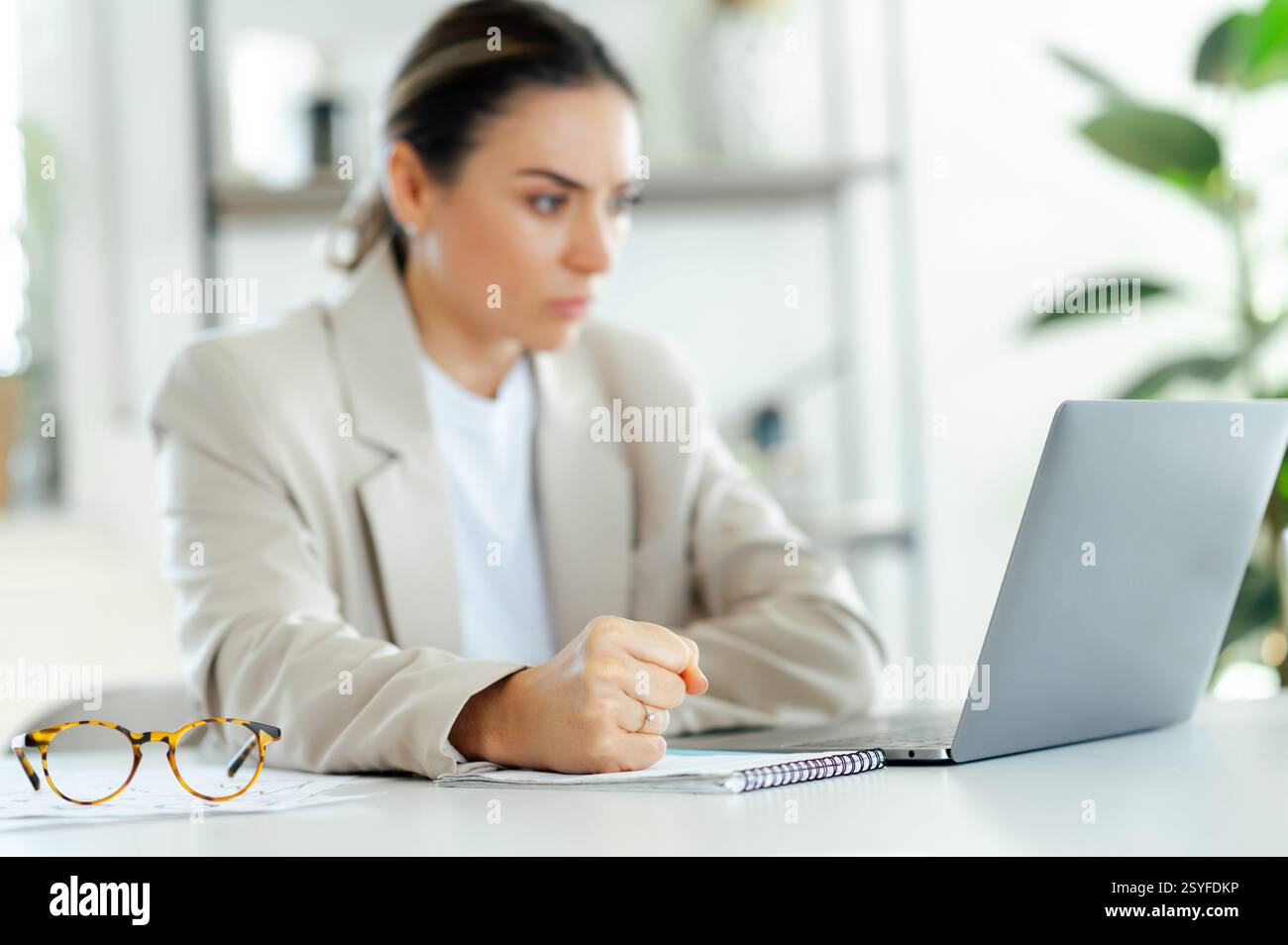 Defocused angry caucasian businesswoman, lady boss clenches her fist on ...