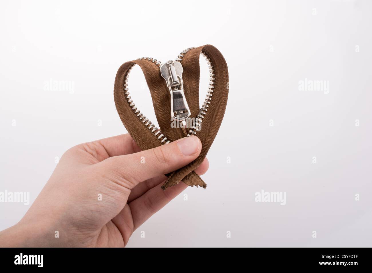 Heart shaped zipper on a white background Stock Photo - Alamy