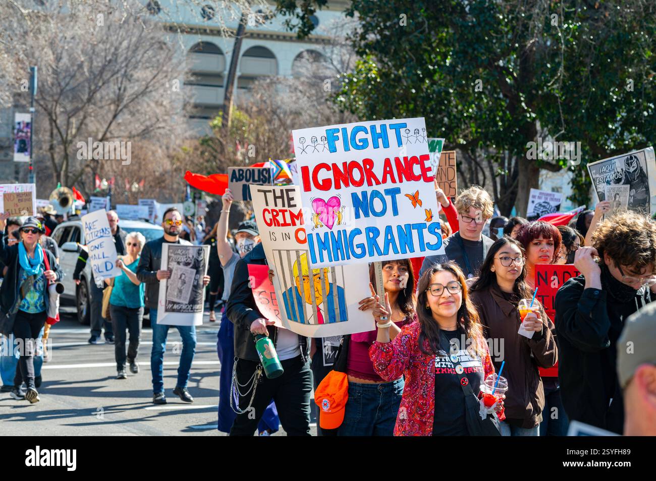 Participants march on I Street with a "Fight Ignorance Not Immigrants ...