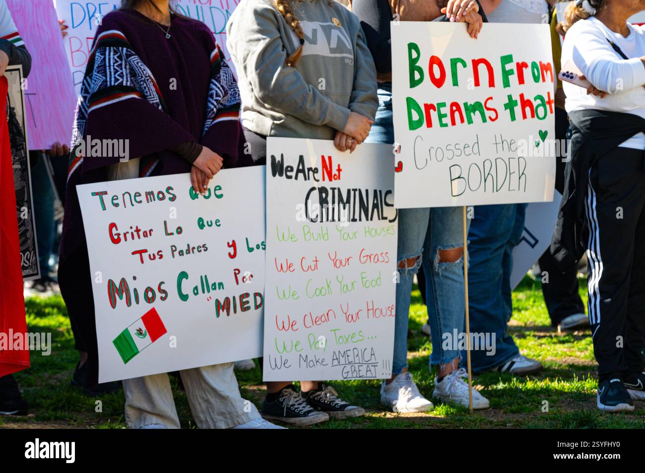 Three young women hold pro-immigration signs at the Pro-immigrant ...
