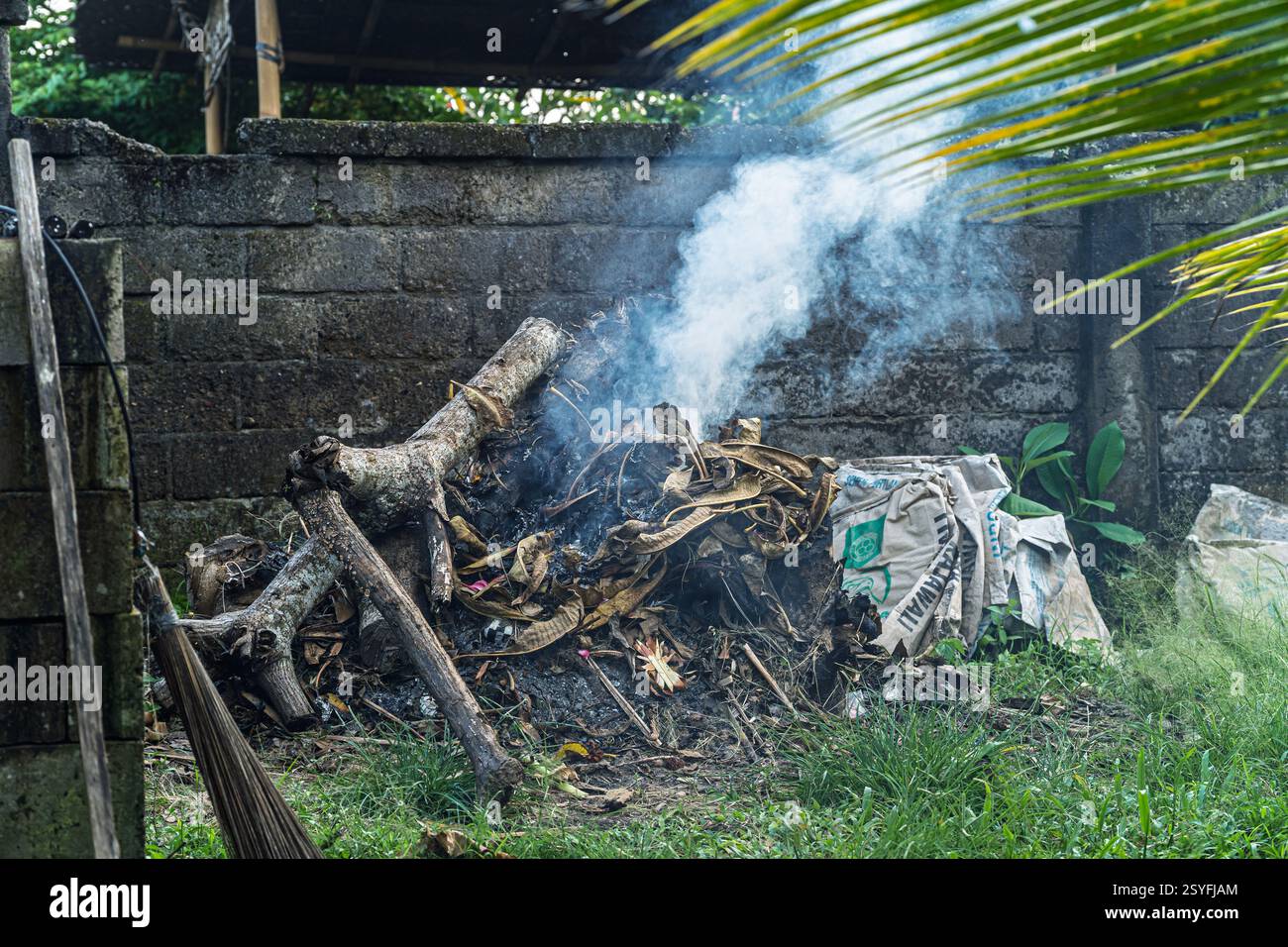 Burning trash or waste produce white smoke. It's burning eco waste like ...