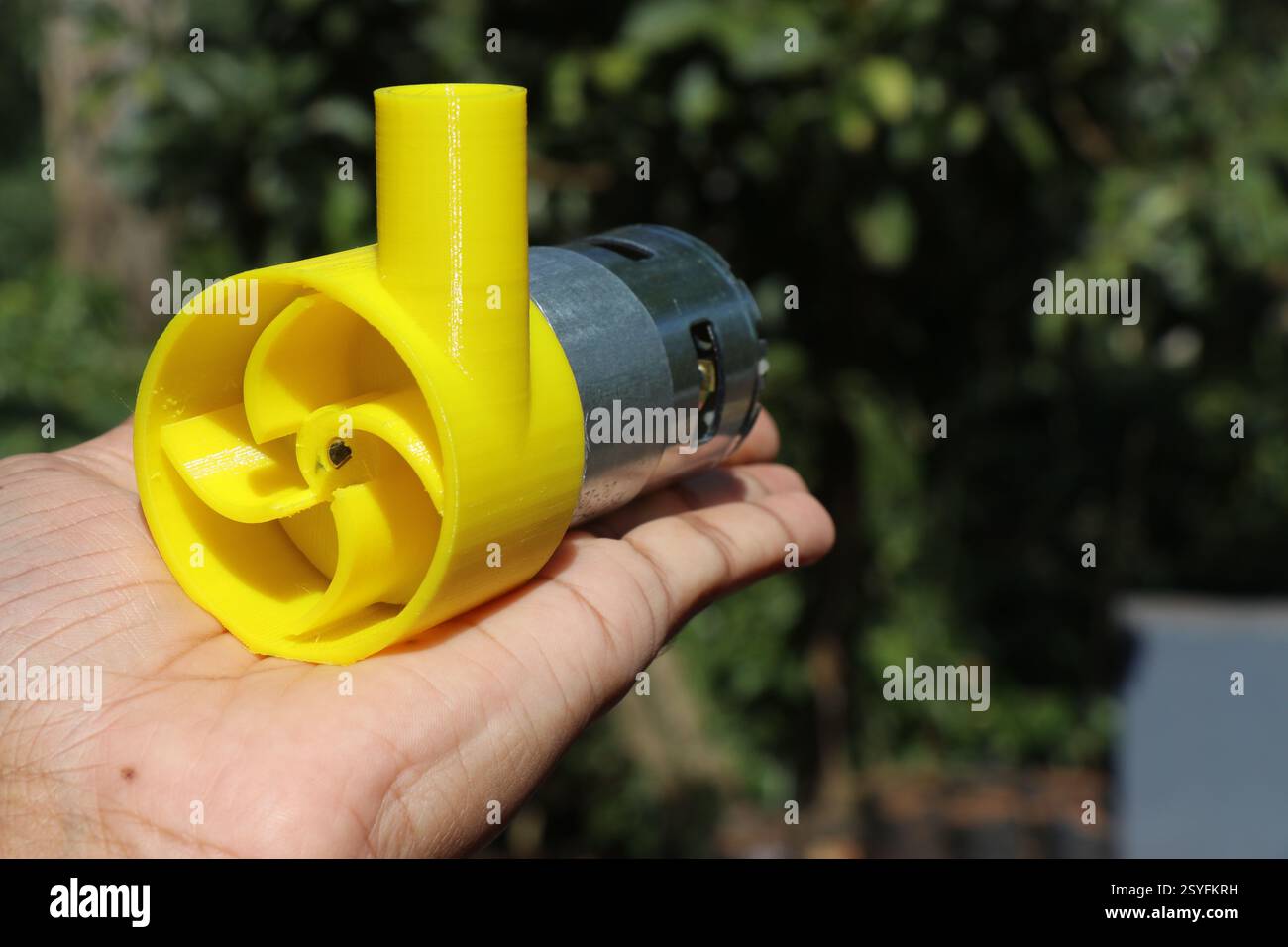Small 3d printed centrifugal water pump with visible impeller held in ...