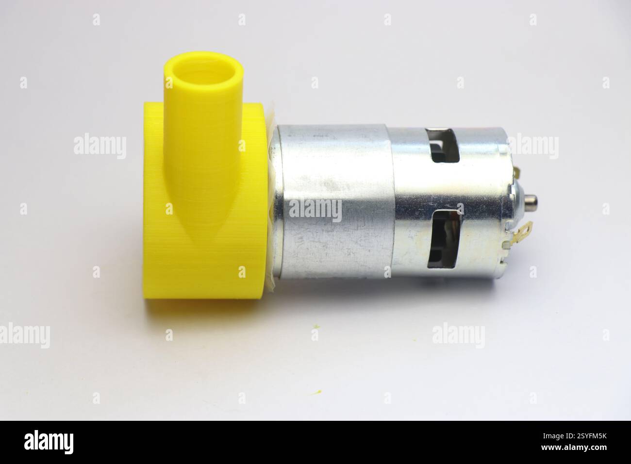 DC motor attached to 3d printed frame isolated on a white background ...