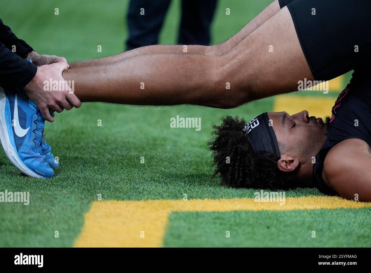 North Carolina tight end Bryson Nesbit is measured at the NFL football ...