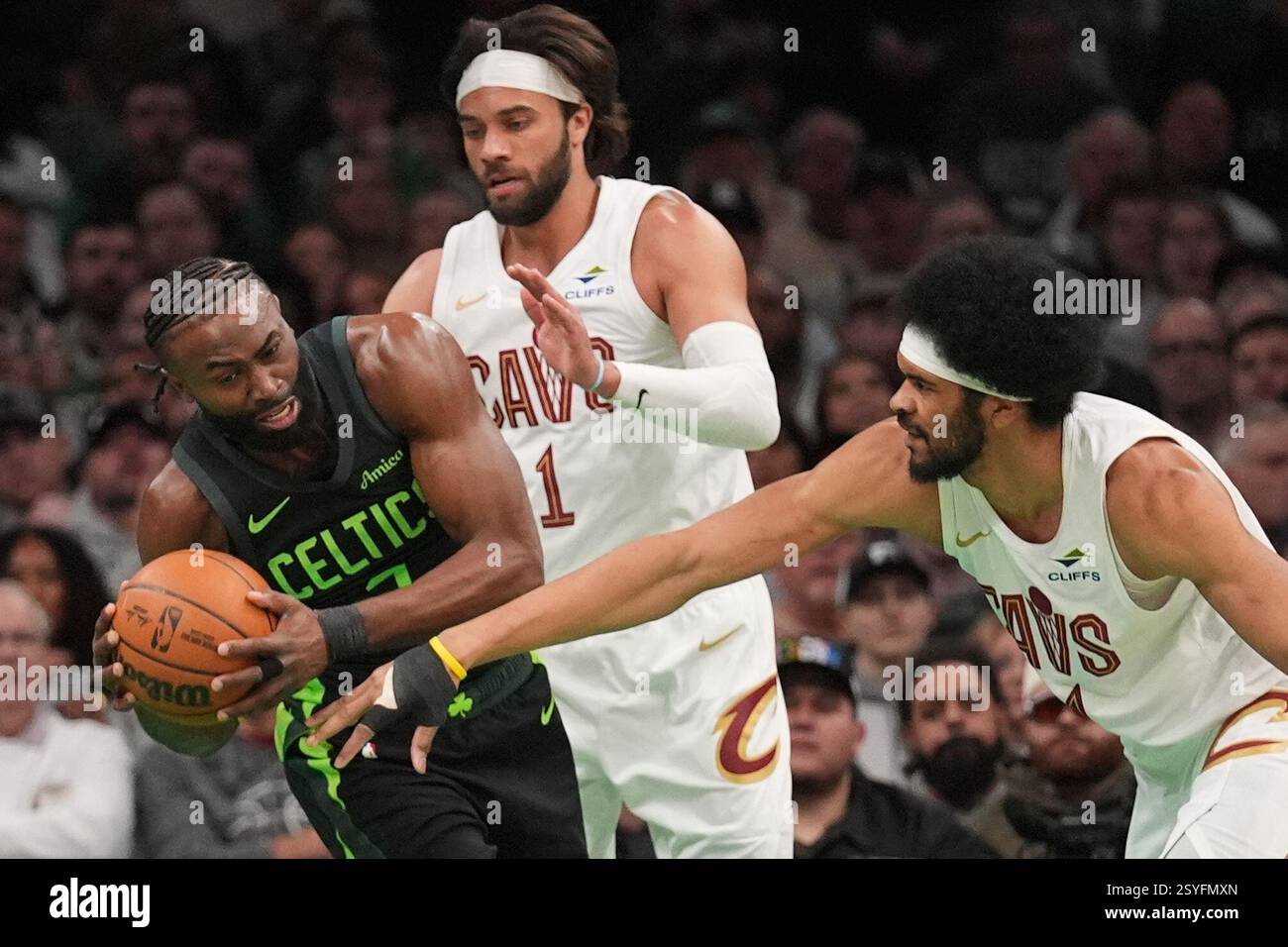 Boston Celtics guard Jaylen Brown, left, is pressured by Cleveland ...