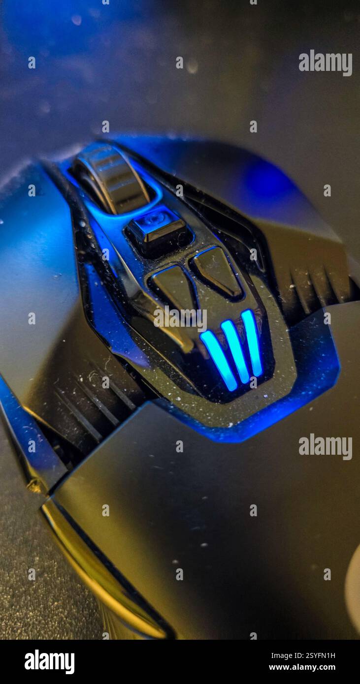 Close-up of a gaming mouse featuring vibrant blue LED lights. The ...