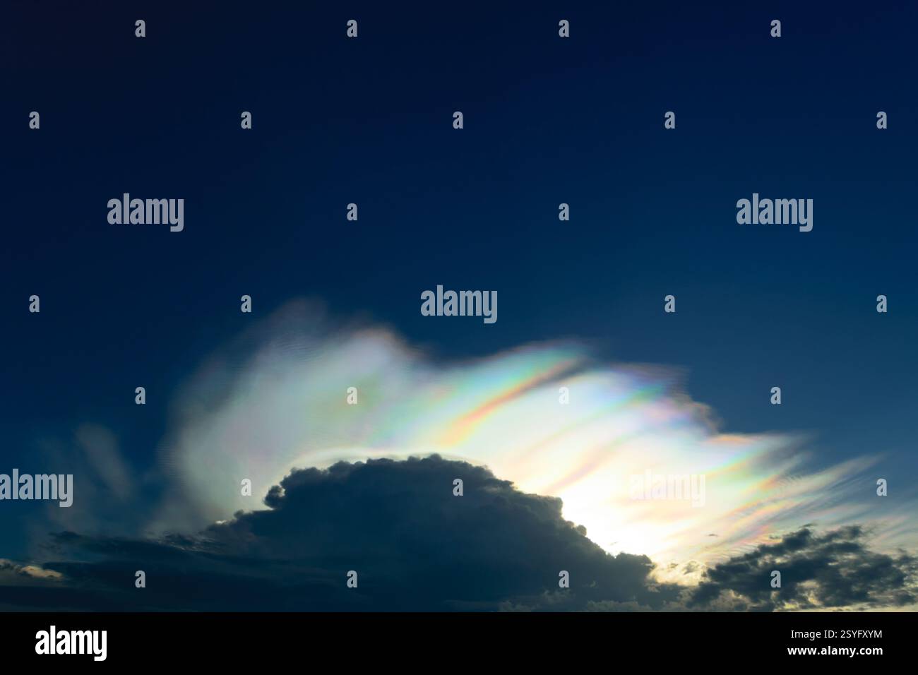 Rare fire rainbow in dark stormy clouds (circumhorizontal arc). No ...