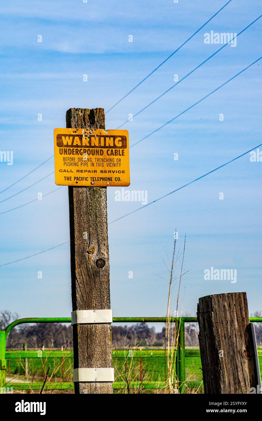 An old Pacific Bell sign warning of underground phone cable with ...