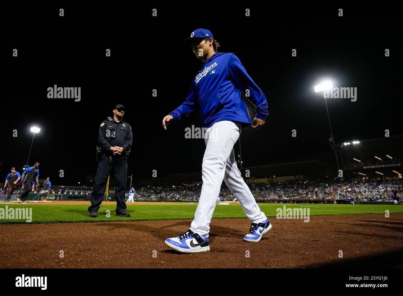 Los Angeles Dodgers relief pitcher Yoshinobu Yamamoto leaves the dugout ...