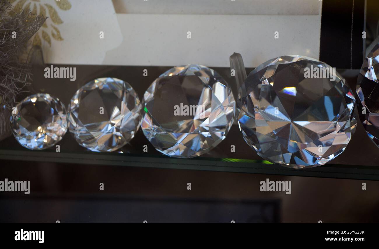 Five transparent diamonds aligned from small to big on display Stock ...