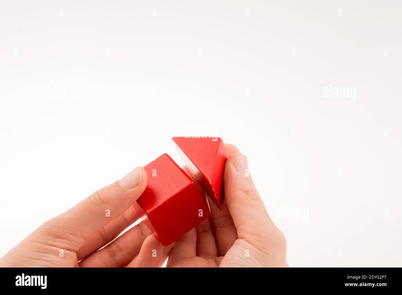 Hand making house with colorful cubes on a white background Stock Photo ...