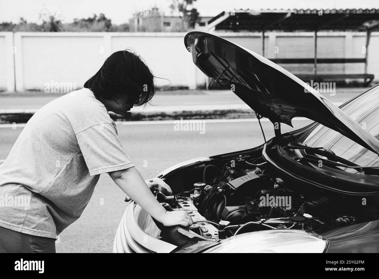 Asian woman 40s alone driver checking a car engine for fix and repair ...