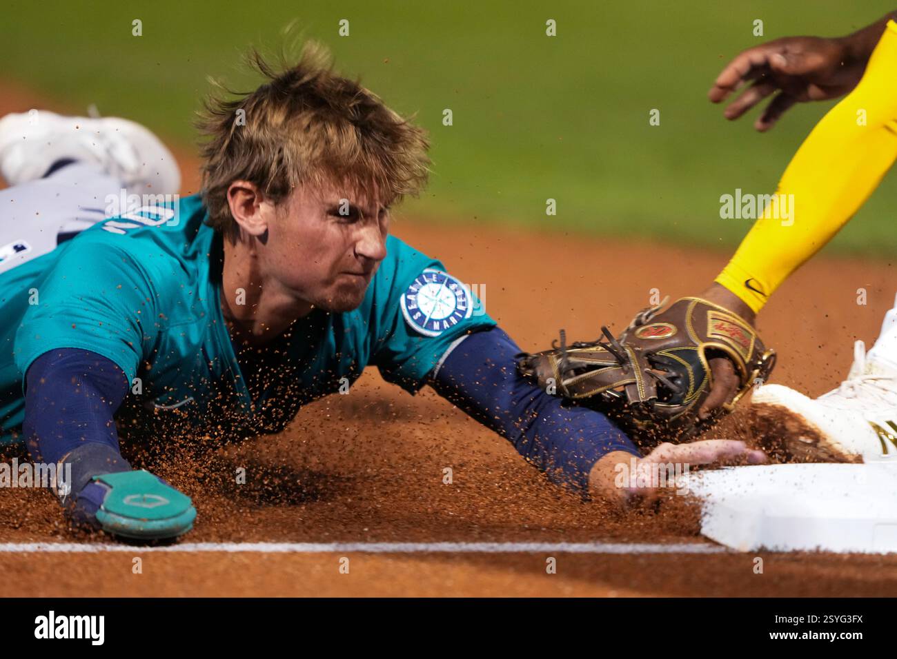 Seattle Mariners' Colt Emerson slides safely into third on a single ...