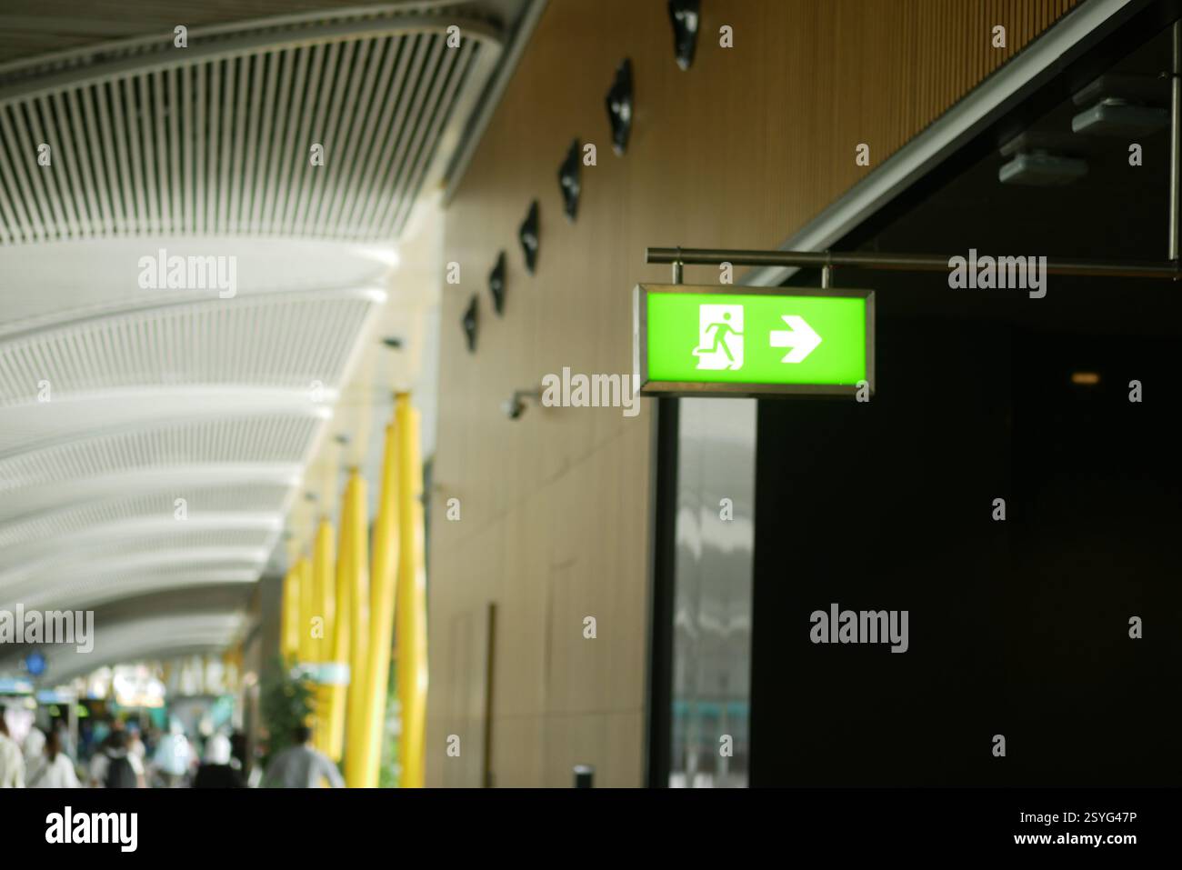 Emergency exit sign in modern indoor airport terminal area Stock Photo ...