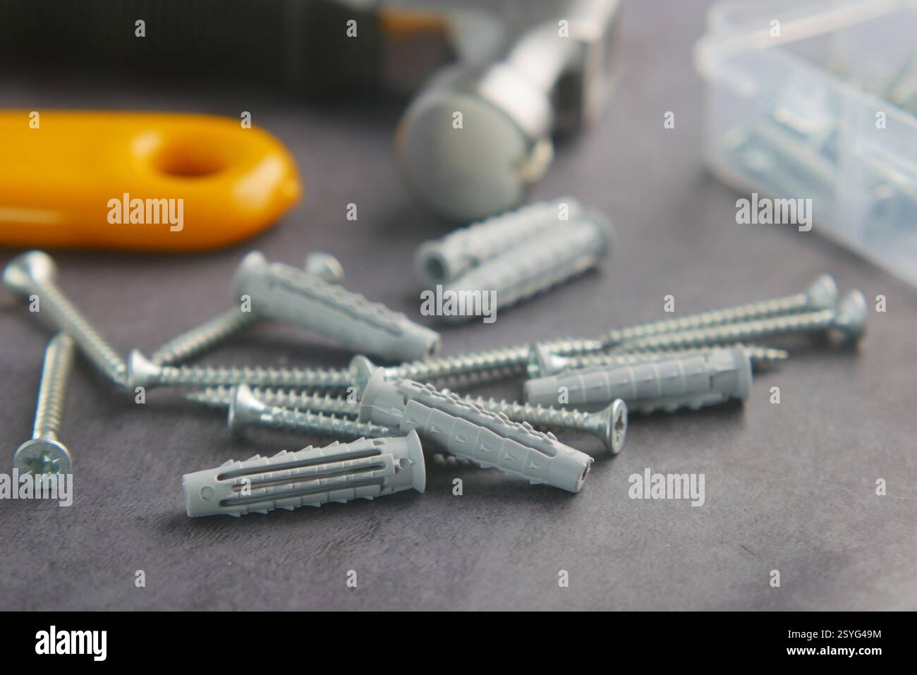 Various screws and anchors arranged on a work surface with tools Stock ...