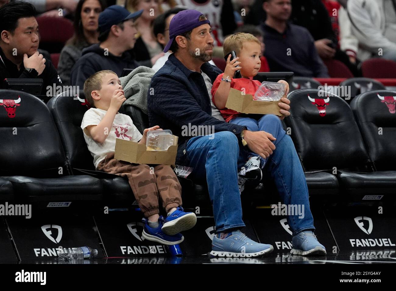 Phoenix Suns owner Justin Ishbia, center, sits courtside during the ...