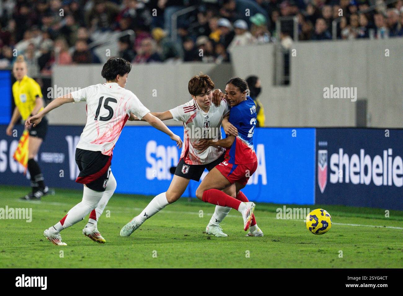 United States forward Yazmeen Ryan (22) tries to hold off Japan ...