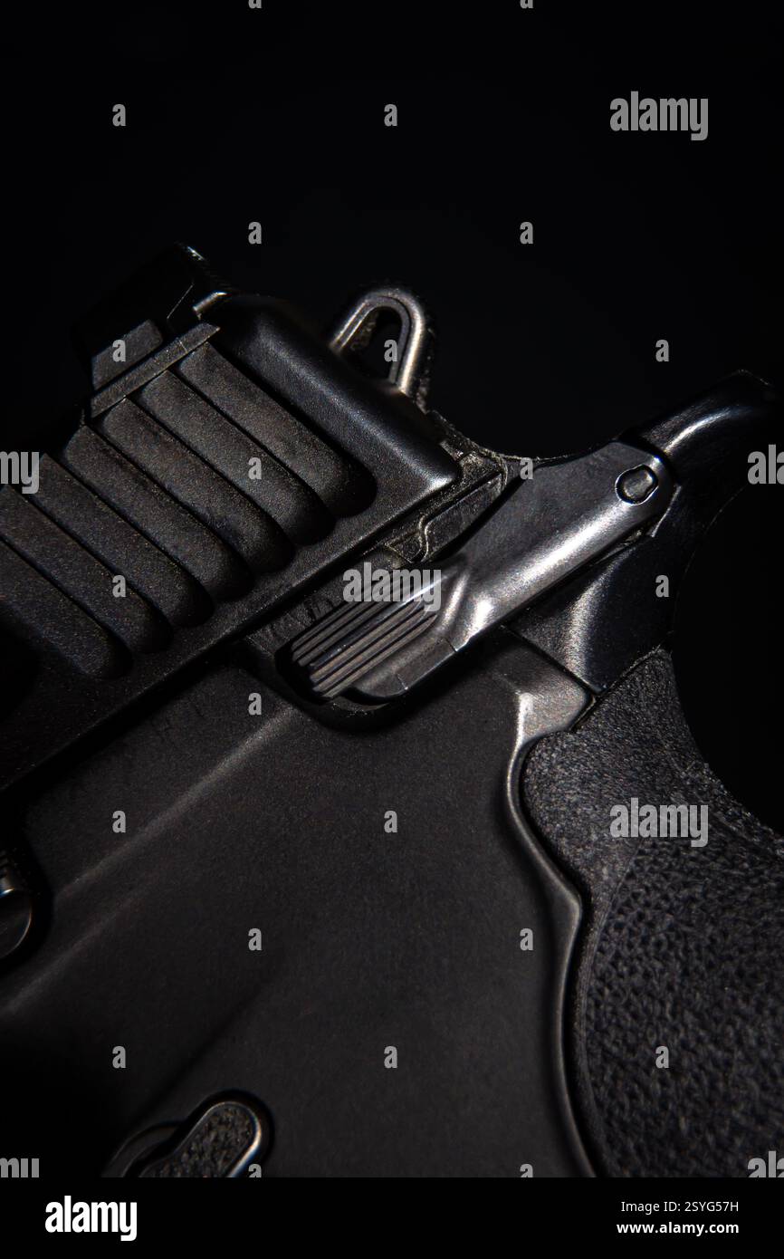 Close-up shot of a hammer fired pistol with its safety mechanism turned ...