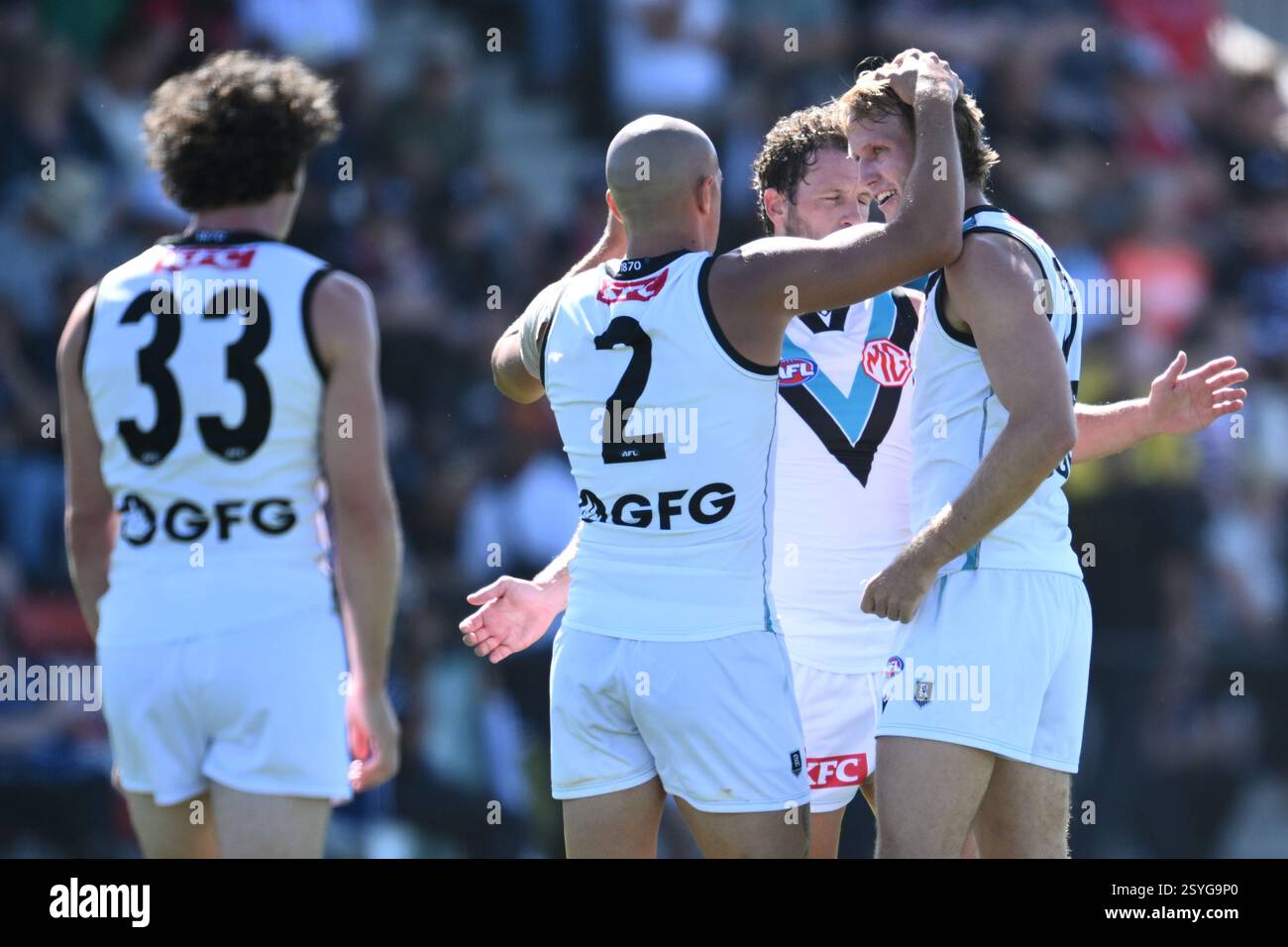 Jack Lukosius of Port Adelaide (right) celebrates scoring a goal during ...