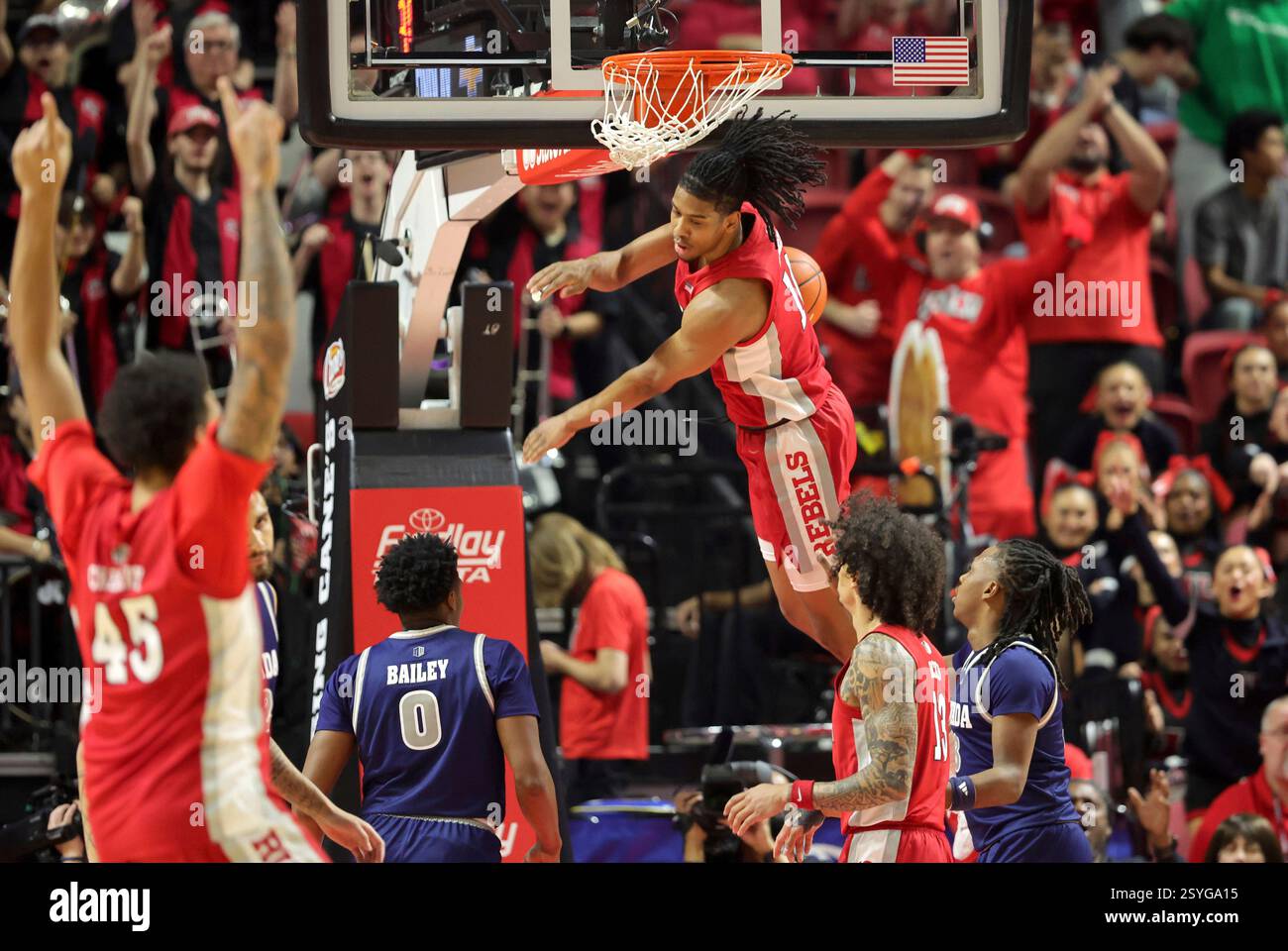 UNLV guard Jaden Henley (10) dunks over UNR guard Chuck Bailey III (0 ...