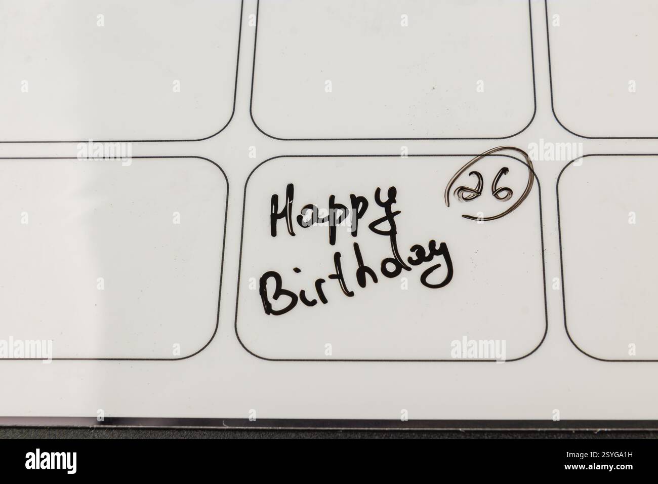 A handwritten birthday message is clearly visible on a calendar with a ...
